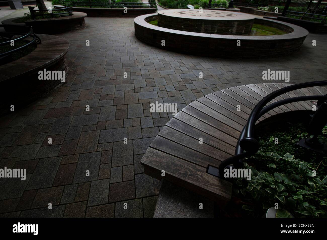 An empty bench in an urban square Stock Photo - Alamy