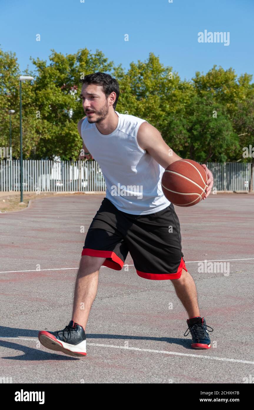 Male playing basketball in the fresh air Stock Photo - Alamy