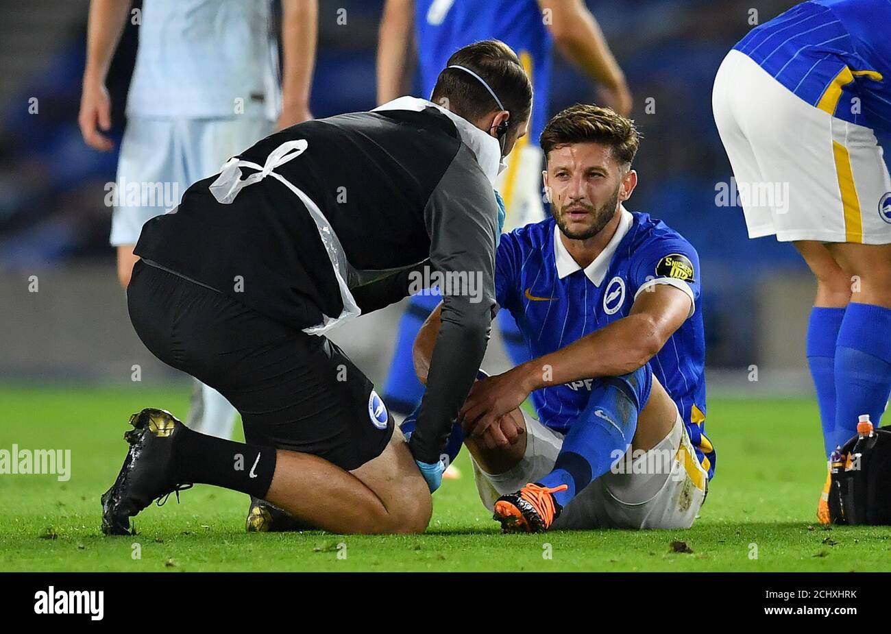 Brighton and Hove Albion's Adam Lallana receives treatment for an ...
