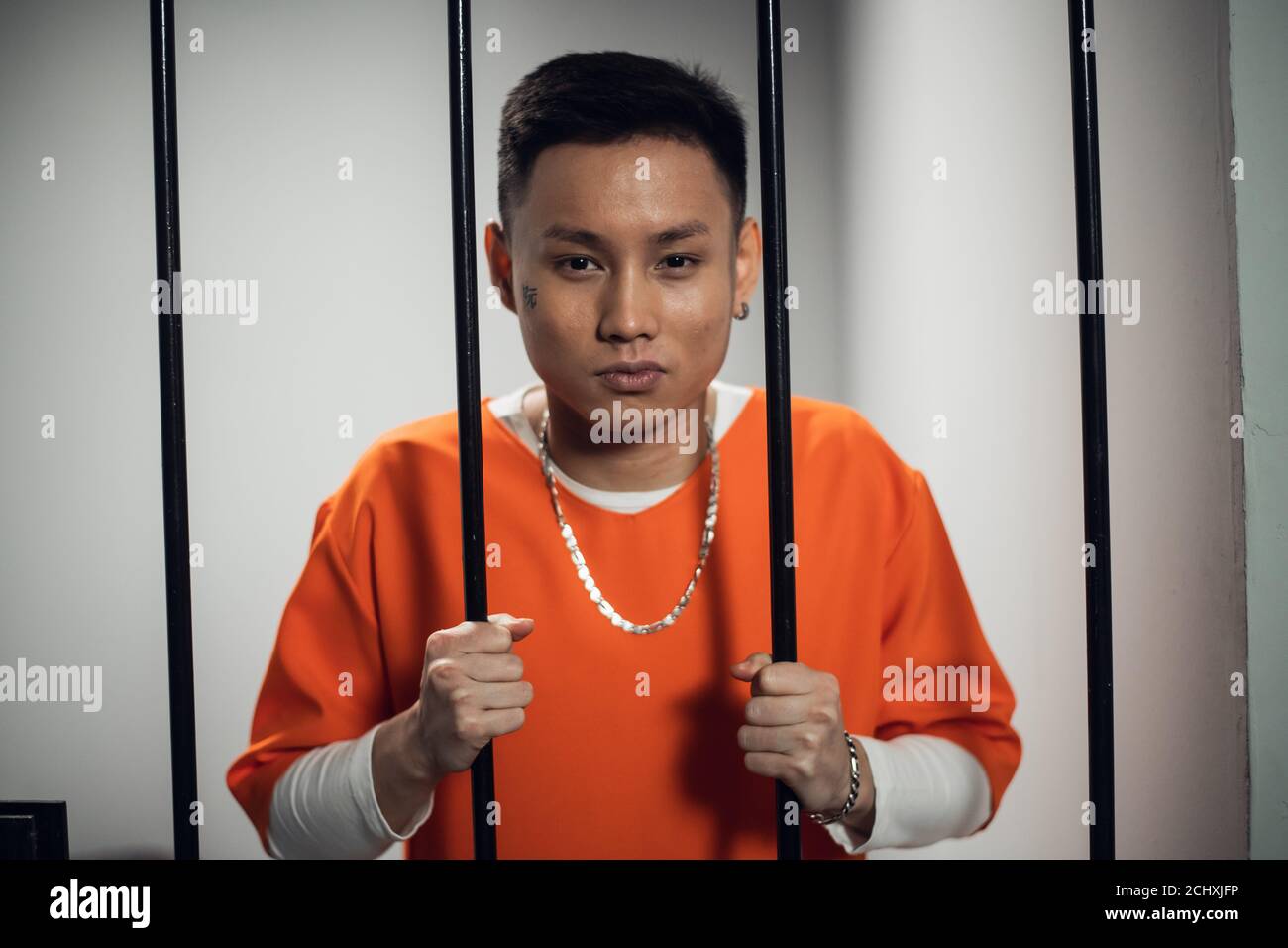 Stands behind iron bars hi-res stock photography and images - Alamy