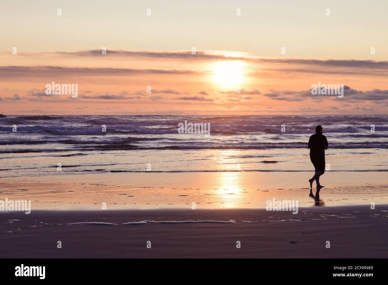 Woman walking beach sunset hi-res stock photography and images - Alamy