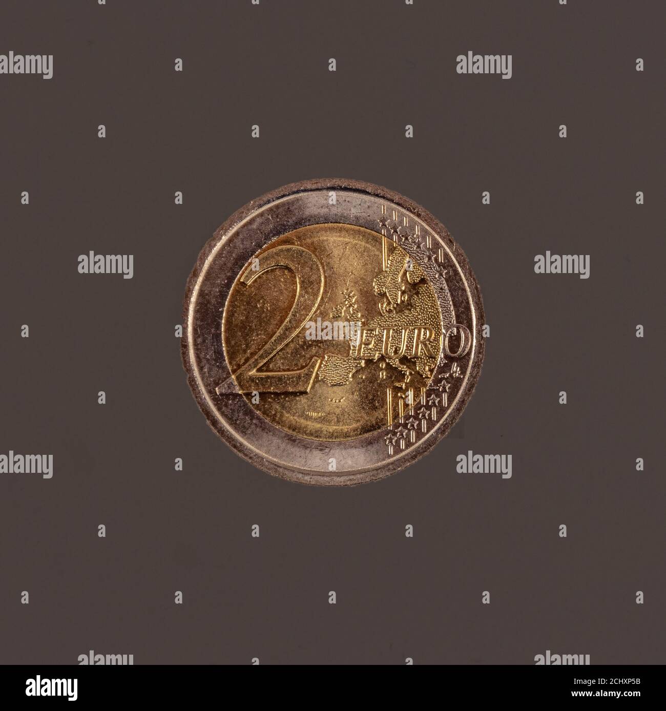 Close up of a two euro coin isolated on dark background Stock Photo - Alamy