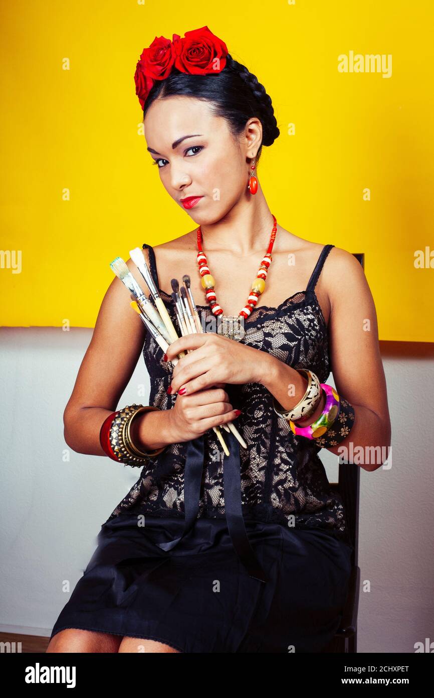 young pretty mexican woman smiling happy on yellow background ...