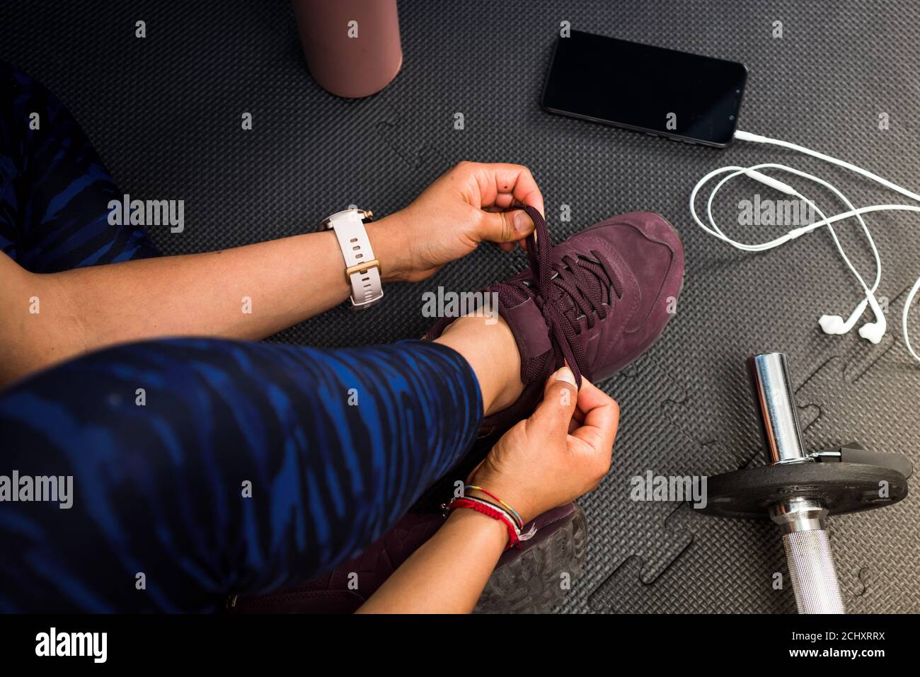 Closeup shot of a fit female tying her shoe before a workout Stock ...