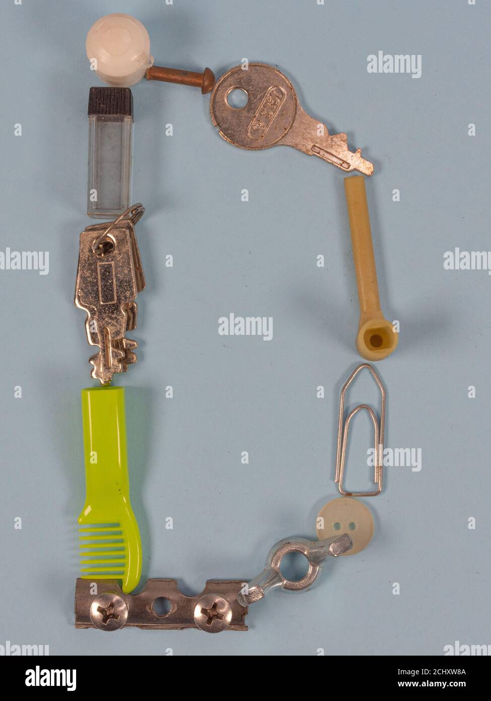 Letter of the alphabet constructed with small various objects on ...