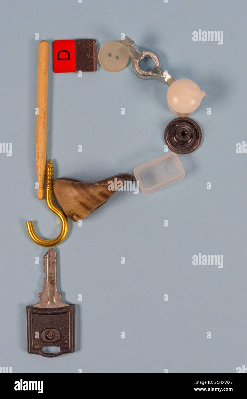 Letter of the alphabet constructed with small various objects on ...