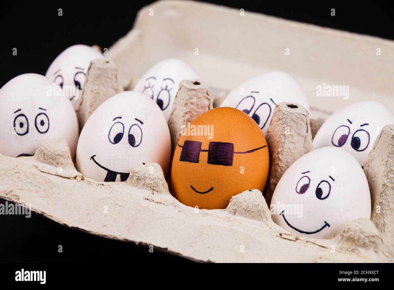 Closeup shot of eggs with funny faces in the package Stock Photo - Alamy