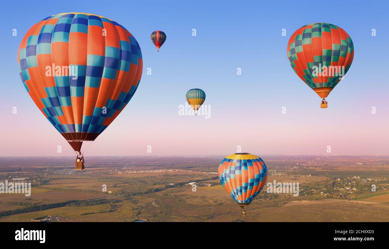 Five colorful balloons in the air over the plains Stock Photo - Alamy