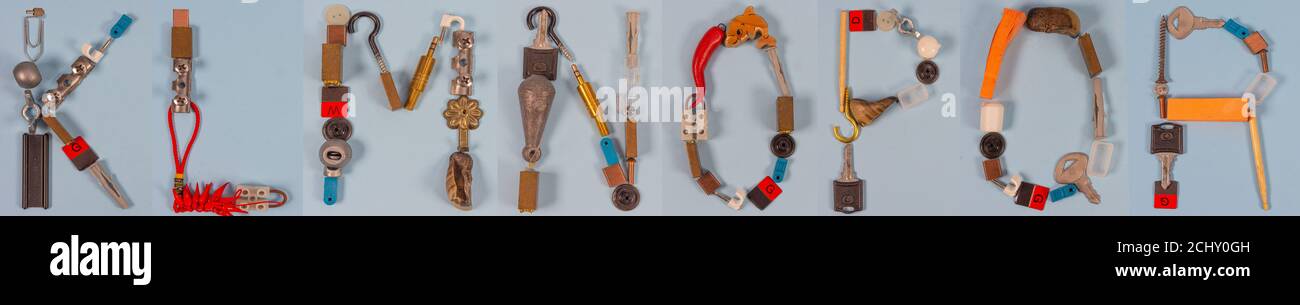 Letters of the alphabet constructed with small various objects on a ...