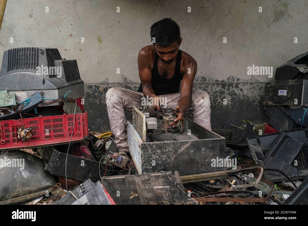 A man is seen working at a TV recycling scrap yard in Dhaka Stock Photo ...