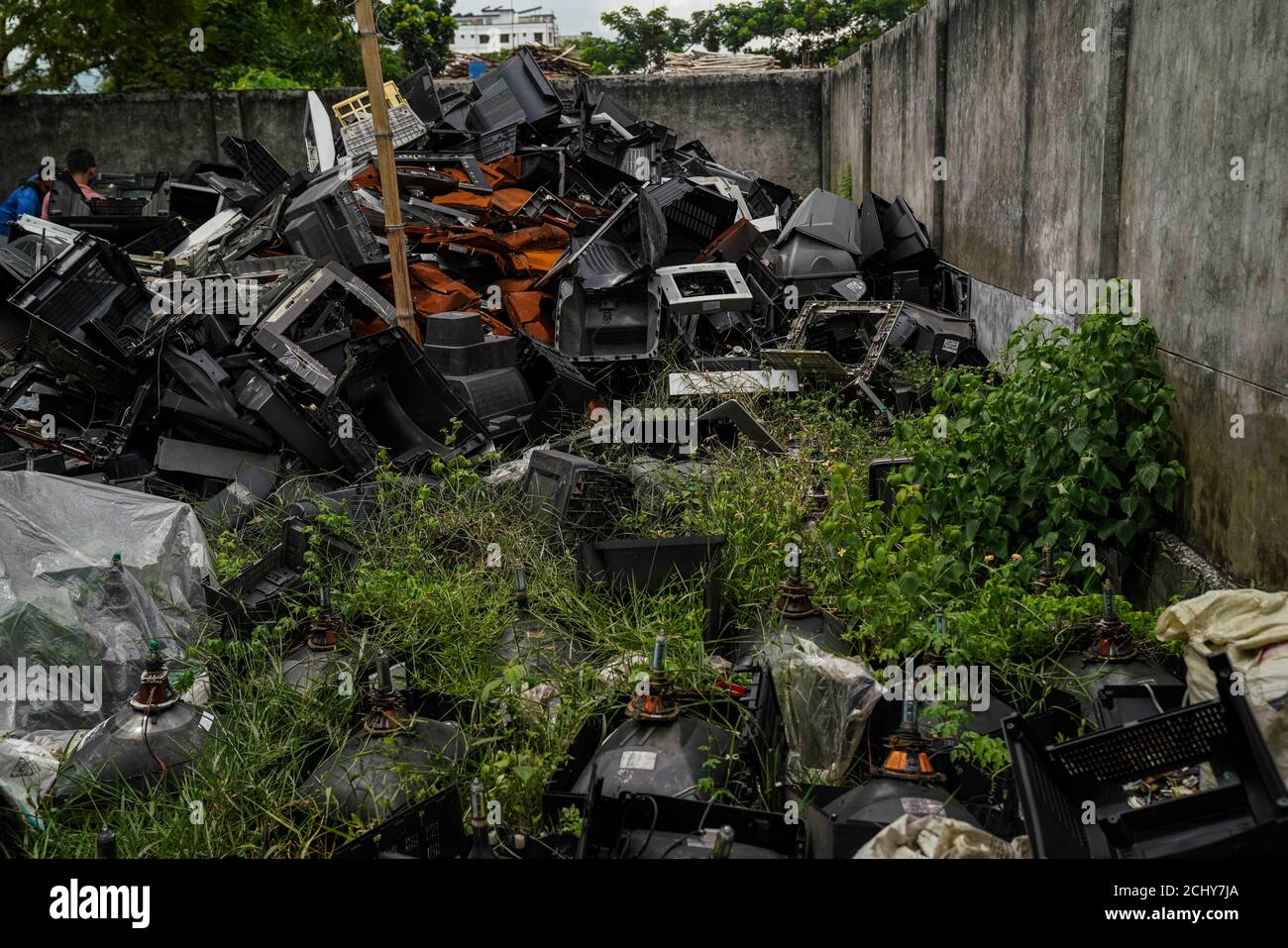Old TV components are discarded inside at a TV recycling scrap yard in ...