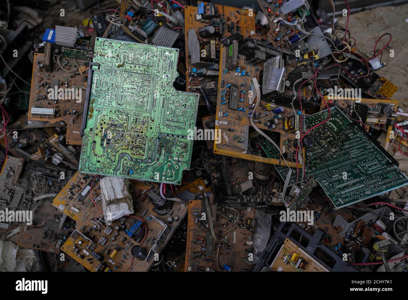 Old TV components are discarded inside at a TV recycling scrap yard in ...