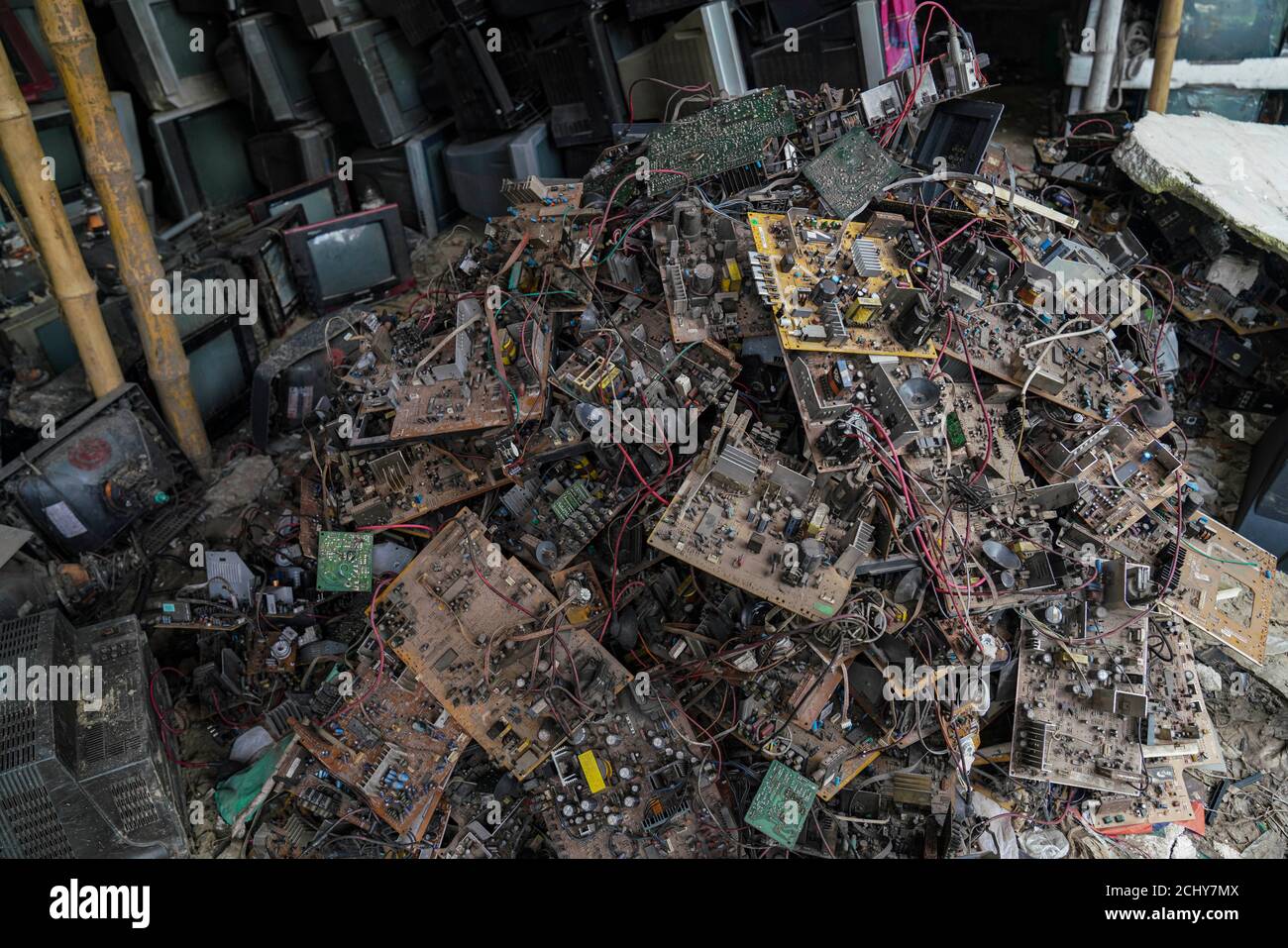 Old TV components are discarded inside at a TV recycling scrap yard in ...