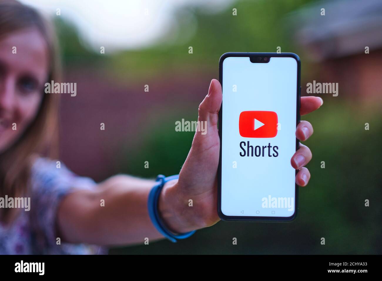 : Youtube Shorts app logo seen on the smartphone which hold by young ...