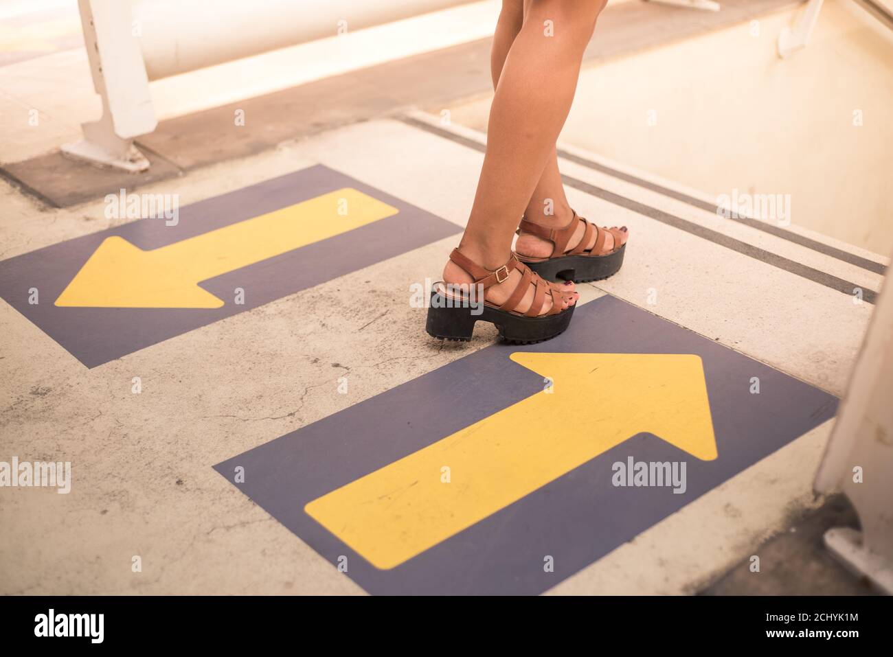 Closeup shot of female feet walking on a surface with arrows Stock ...
