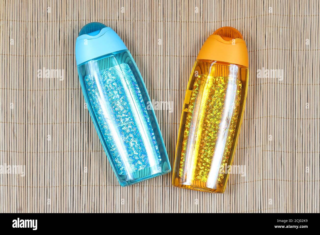 Sparkling shower gel bottles on rattan background Stock Photo - Alamy
