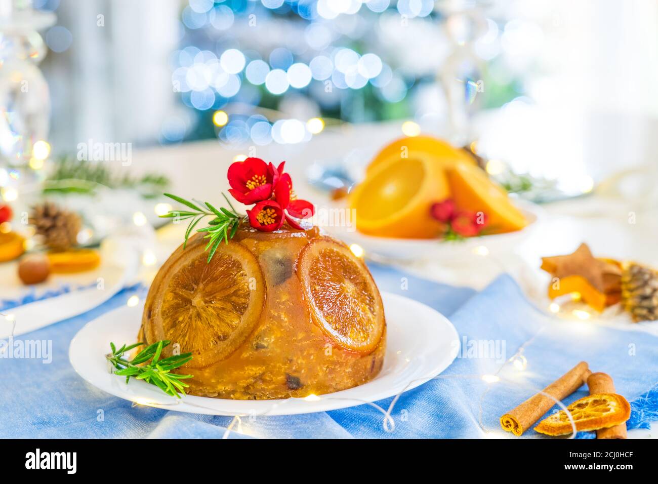 Traditional English Christmas pudding decorated with oranges and ...