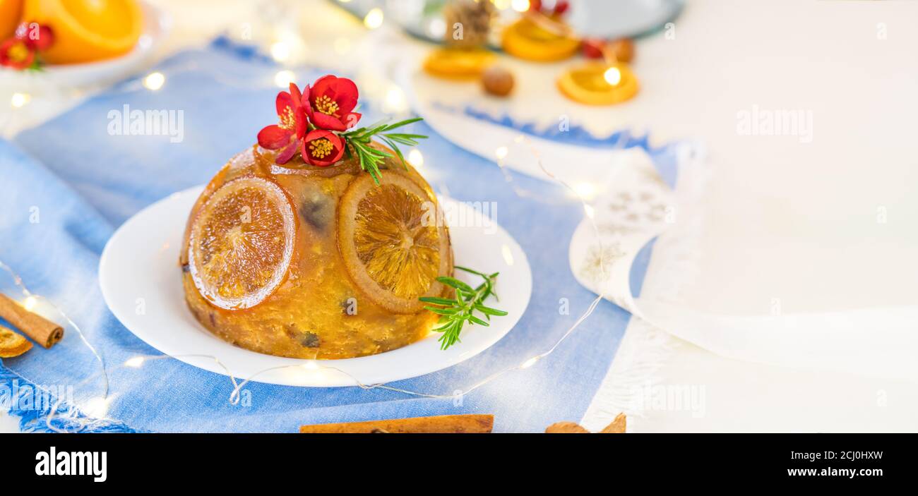 Traditional English Christmas pudding decorated with oranges and ...
