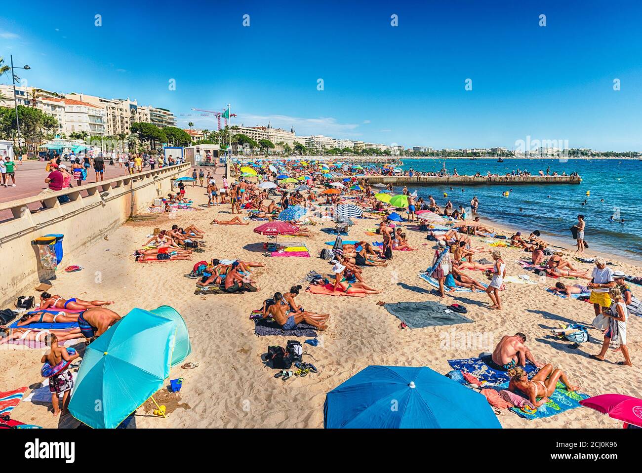 CANNES, FRANCE - AUGUST 15: People enjoying a sunny day on the beach in ...