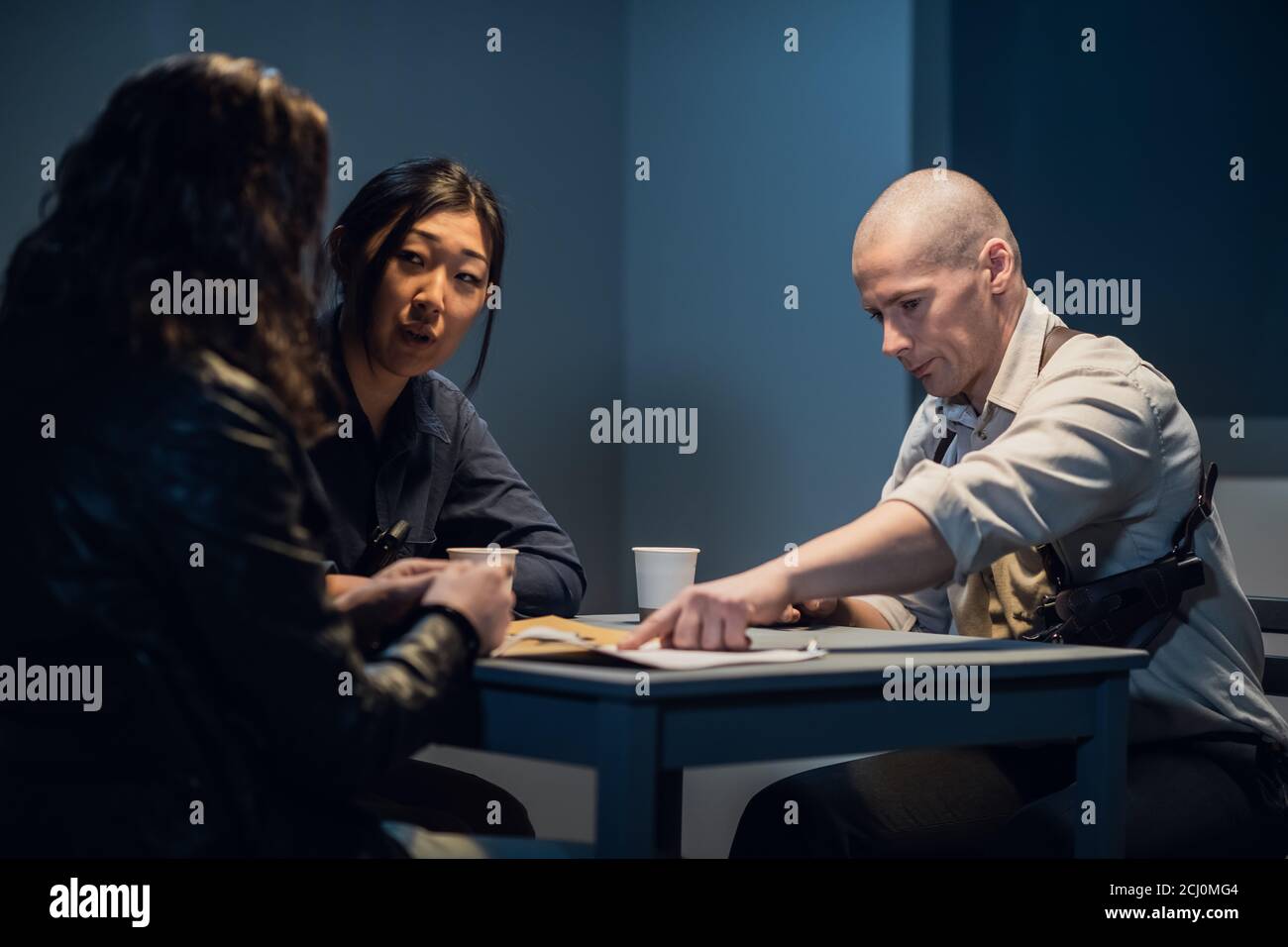 An experienced investigator and a female police officer interrogate the ...