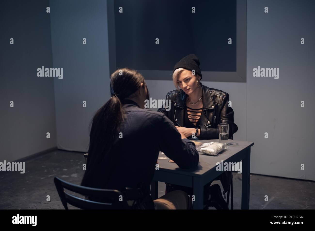 An investigator interrogates a suspected drug dealer in an ...