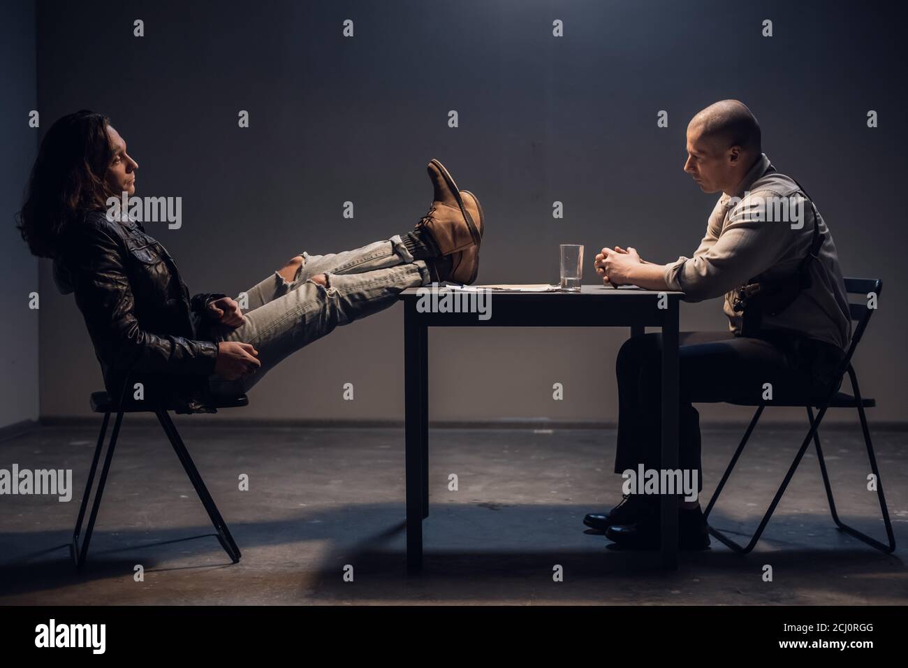 In the interview room, a handcuffed suspect meets with a police or FBI ...