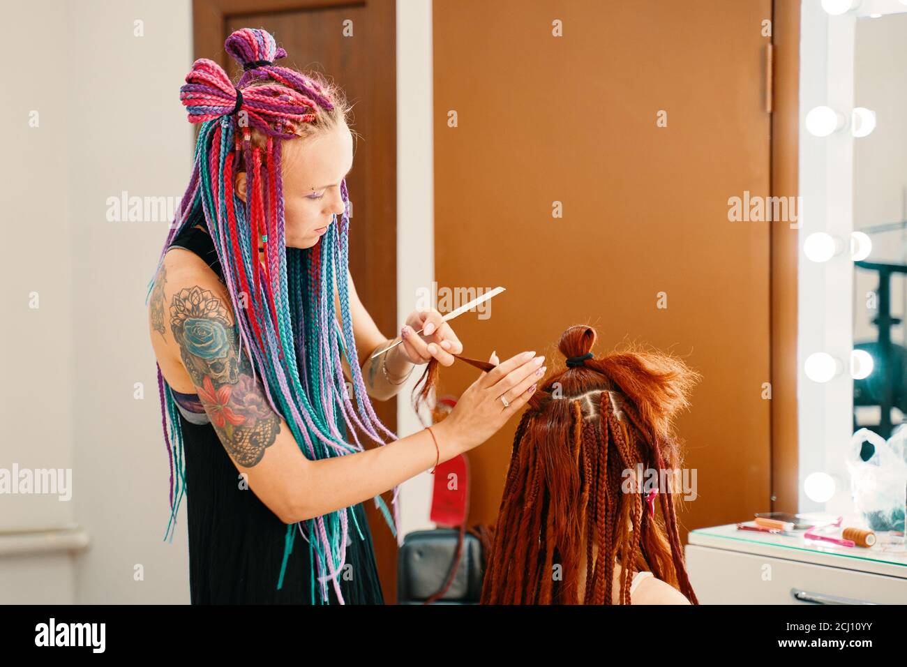 Barber braids dreadlocks. Girl head with braids from the material ...