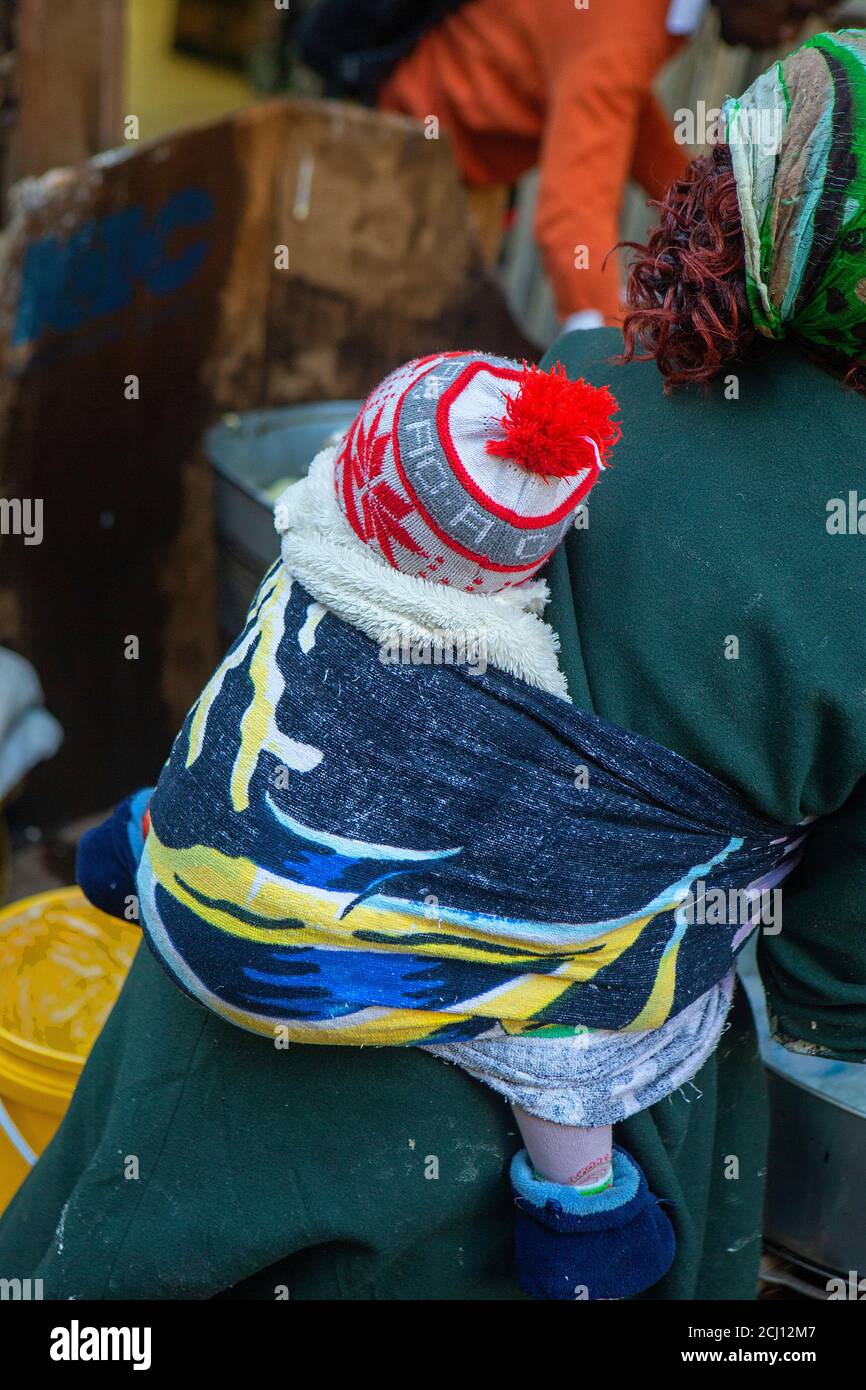 African baby on mother's back in Johannesburg, South Africa Stock Photo ...