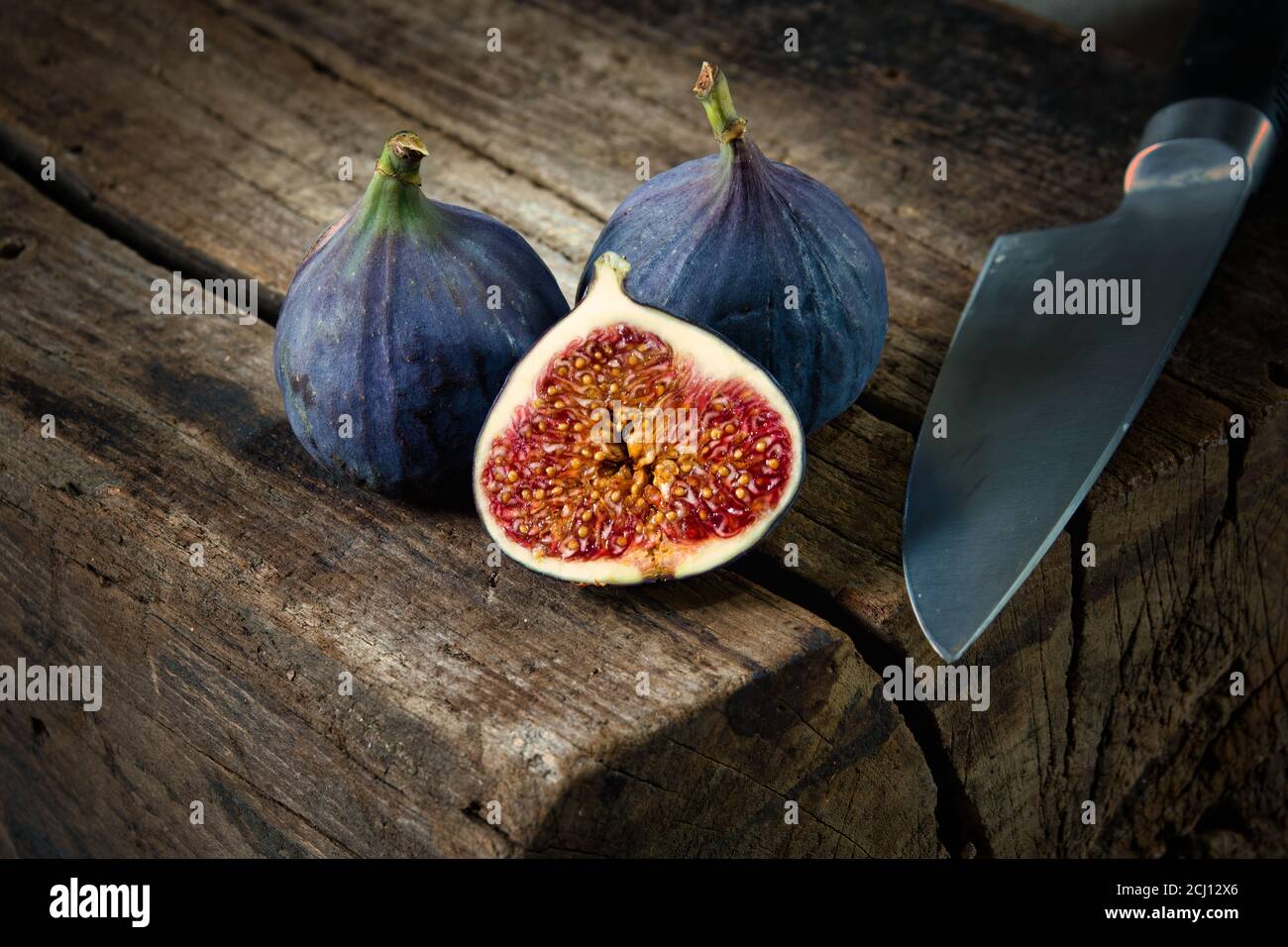 Figs with the knife on the wooden block Stock Photo - Alamy