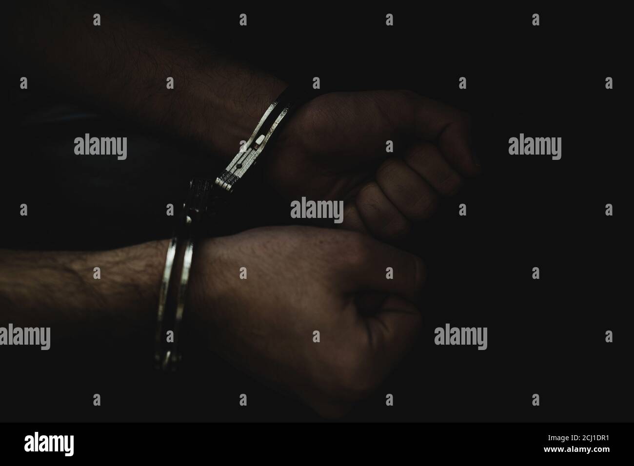 Handcuffed arms hi-res stock photography and images - Alamy