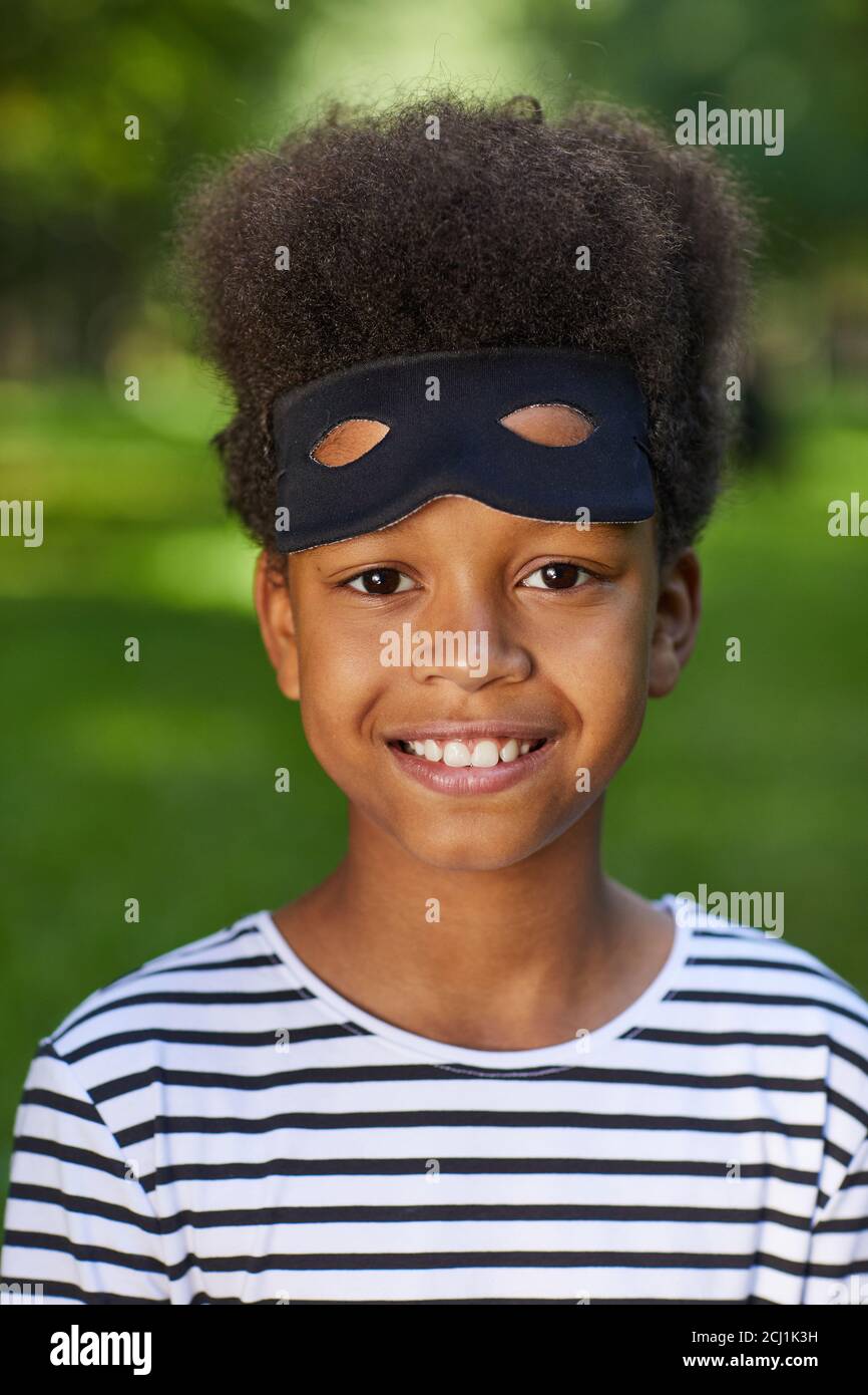 Head and shoulders portrait of smiling African-American boy wearing ...