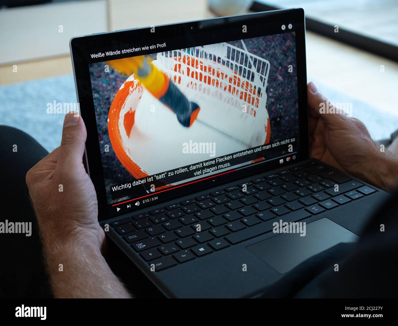 Man watching a YouTube video on tablet (Surface Pro) with craftsman ...