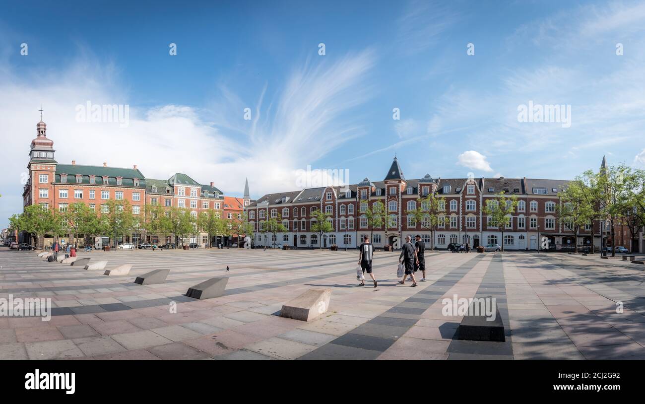 three persons walking over the panoramic square in Fredericia, Denmark ...