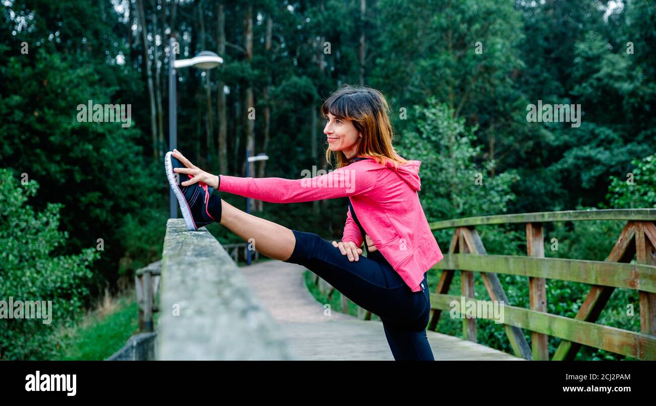 Athlete woman doing leg stretch Stock Photo - Alamy