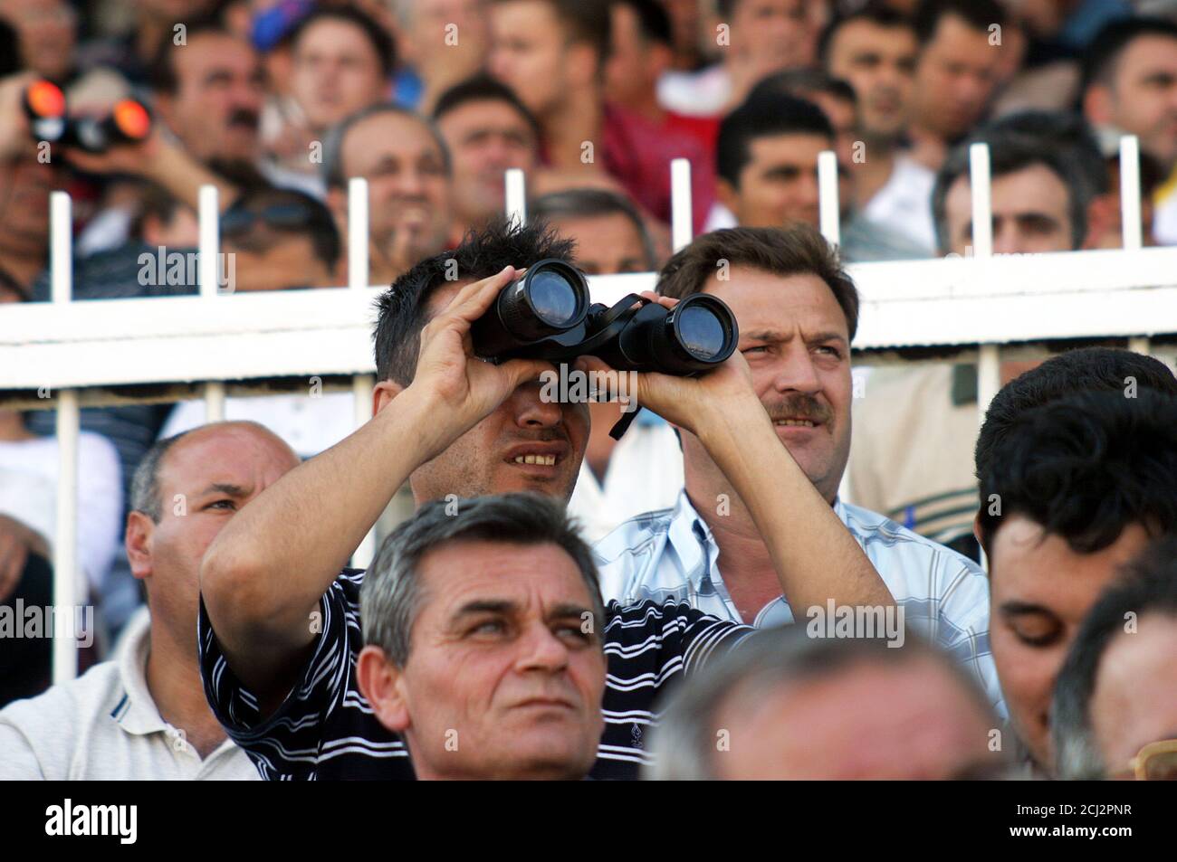 ISTANBUL, TURKEY - JULY 20: Turkish horseracing fans watching the horse ...