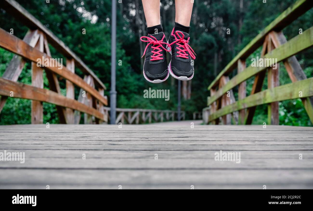 Athlete woman feet jumping outdoors Stock Photo - Alamy
