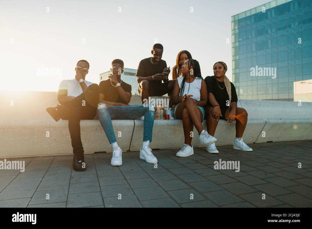 Group of young modern african black friends happily sitting together ...