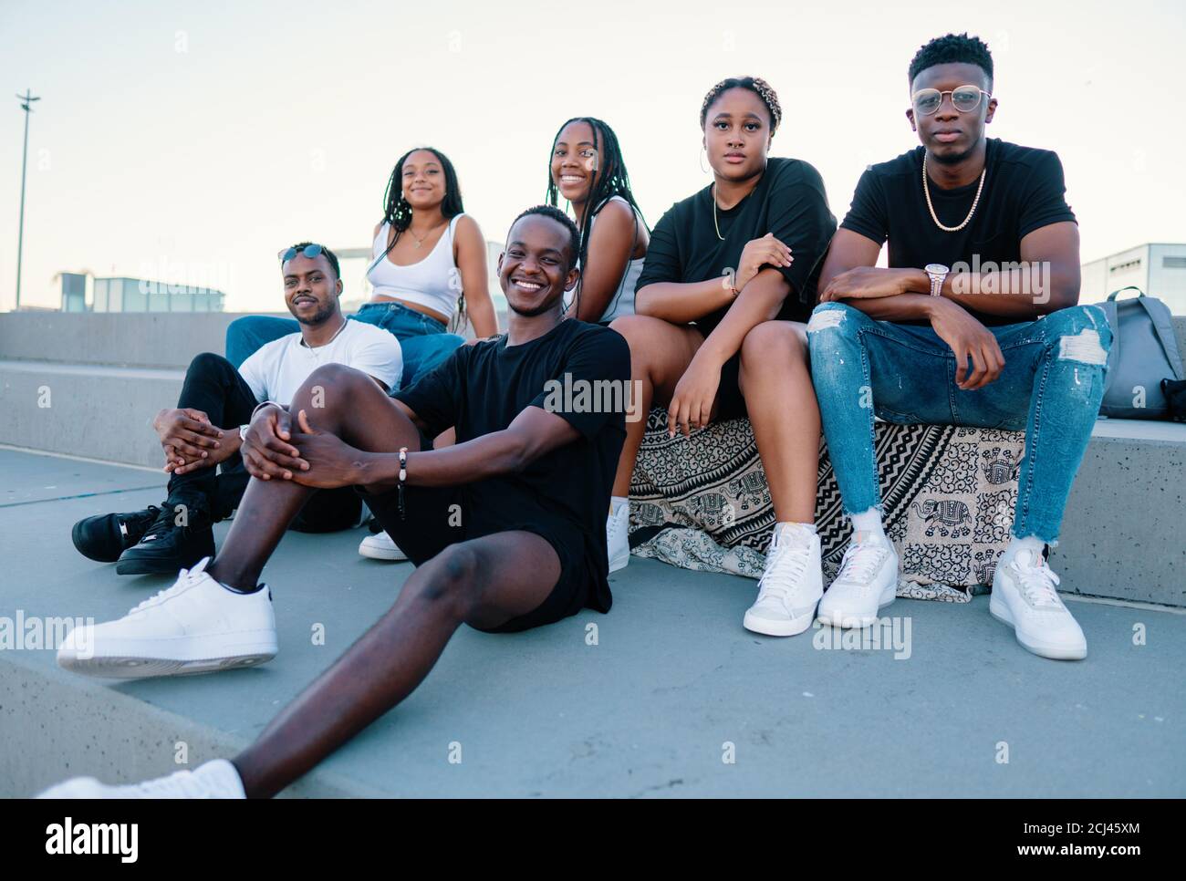 Group of young modern african black friends happily sitting together ...