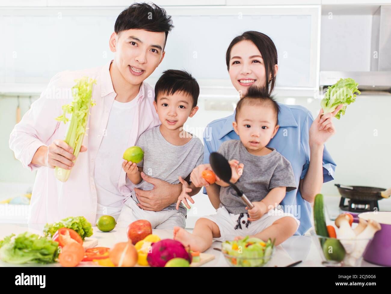 happy family showing healthy food in kitchen Stock Photo - Alamy
