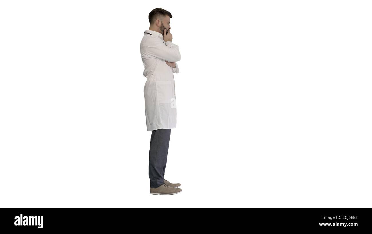 Doctor standing and thinking hard on white background Stock Photo - Alamy