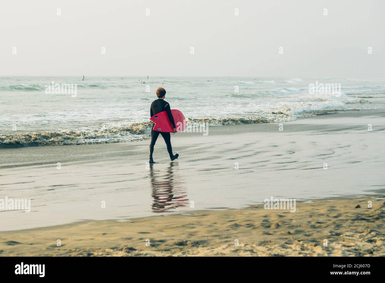 Surfer on the beach in morro bay hi-res stock photography and images ...