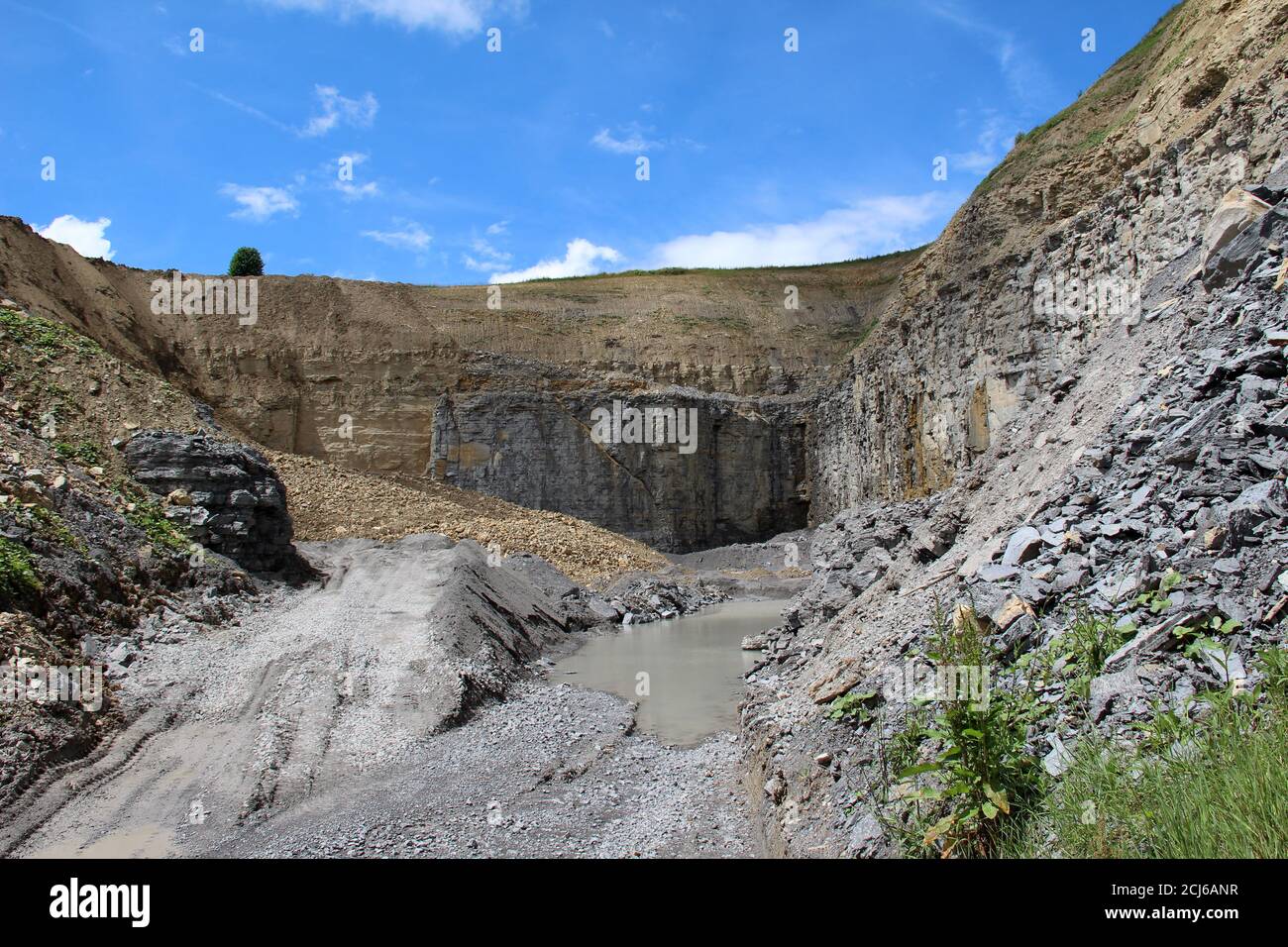 Sunny scenery of a big mine territory in a rocky mountain landscape ...