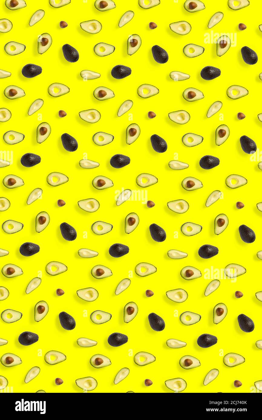 Avocado. Background made from isolated Avocado pieces on yellow ...