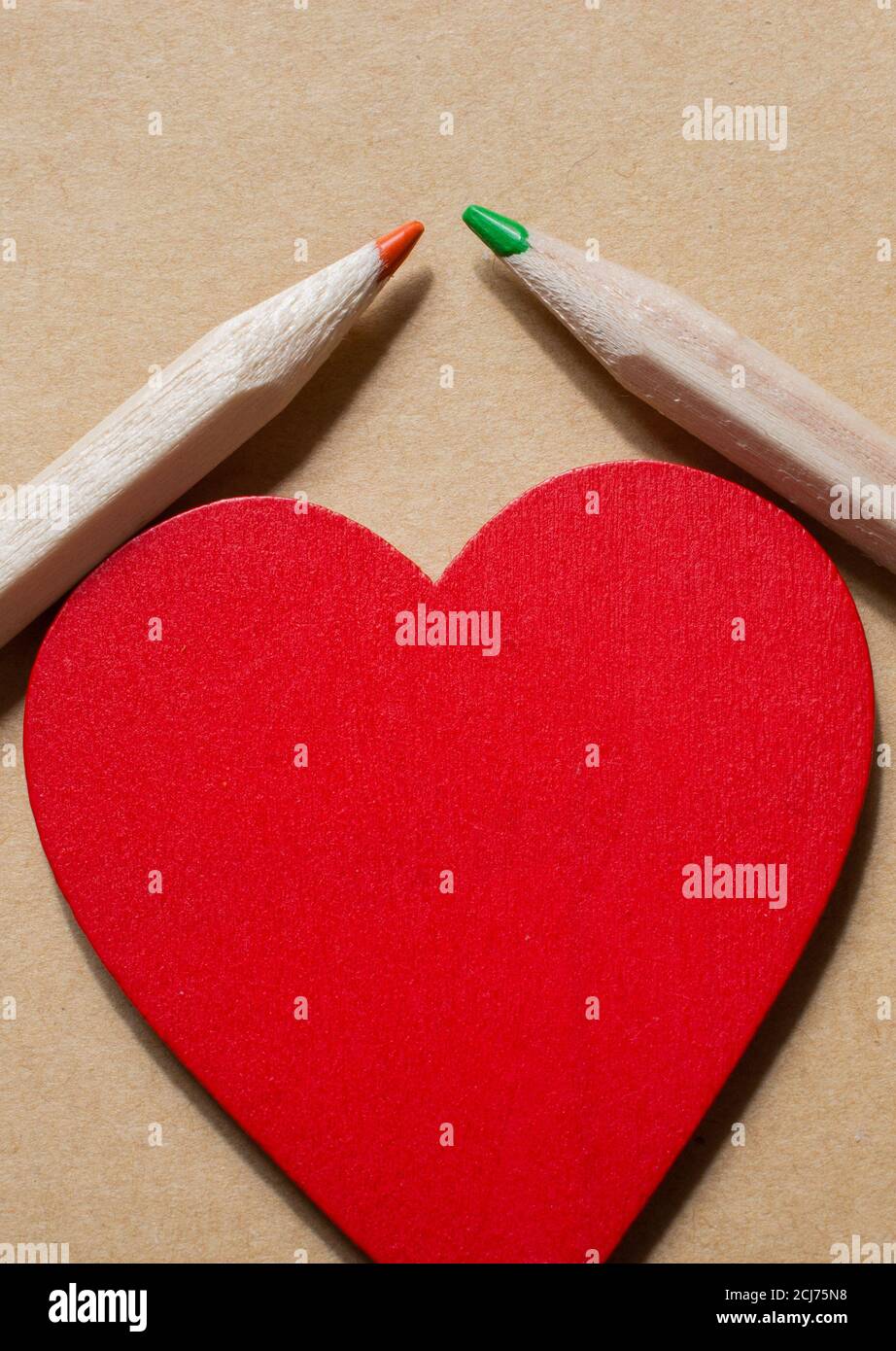 Vertical closeup macro shot of pencils leaning on a heart Stock Photo ...