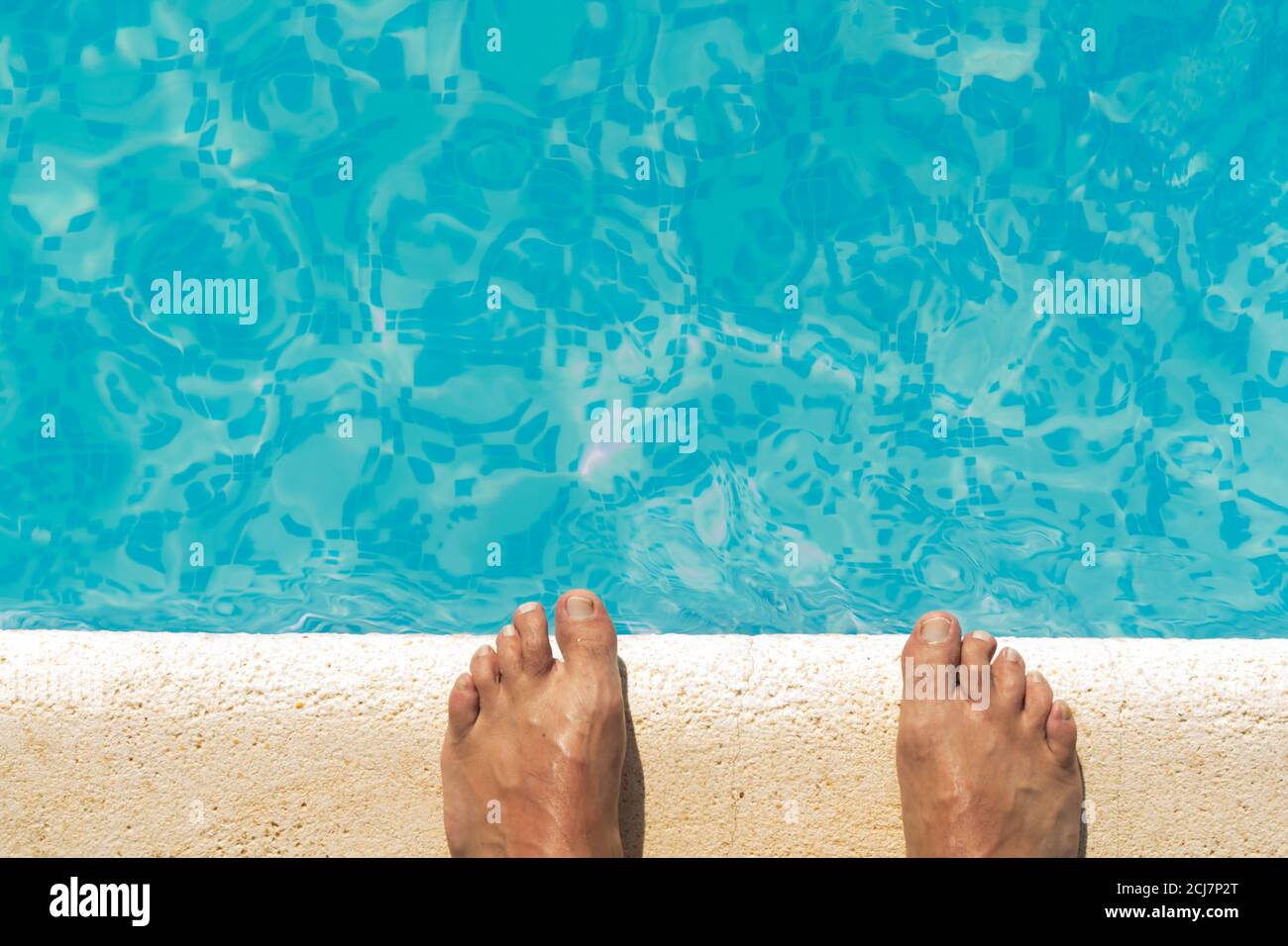 Overhead view of someone's feet on the poolside Stock Photo - Alamy