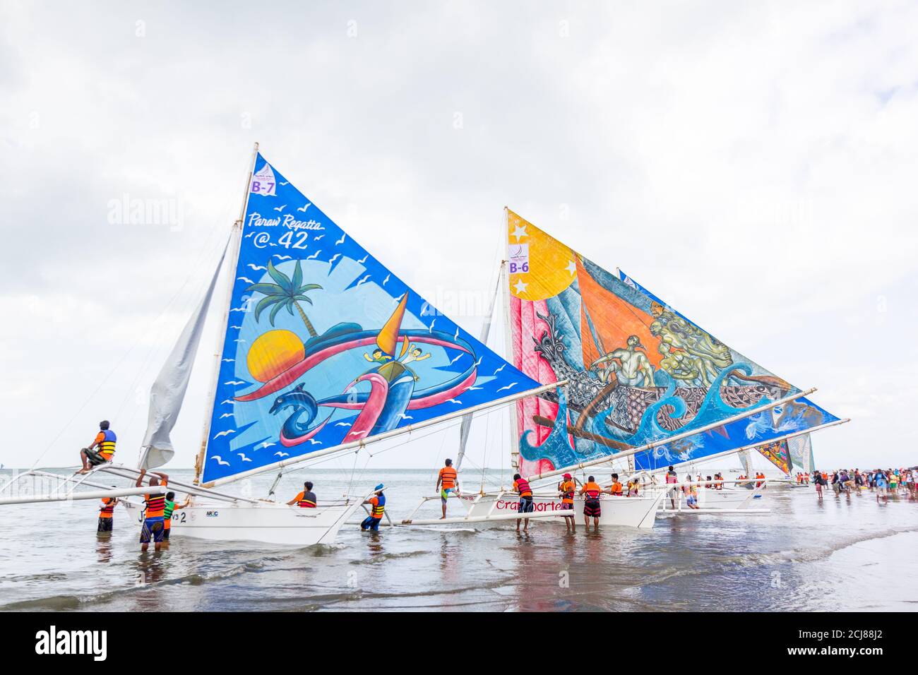 Colorful sailboats locally called paraw at the banks of Villa beach in ...