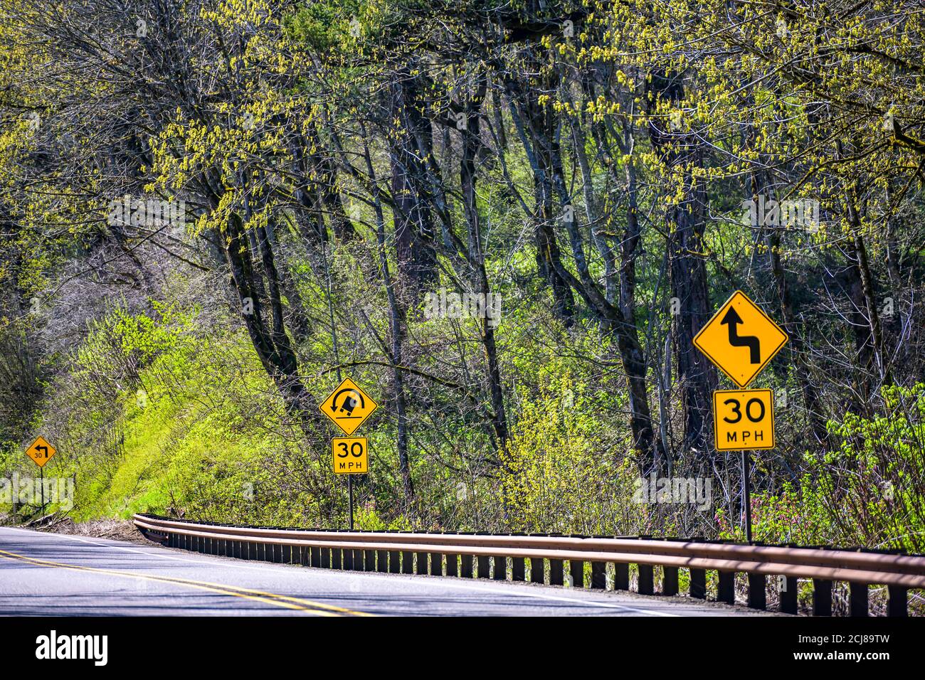 A road with a dividing lane for traffic in opposite directions passes ...