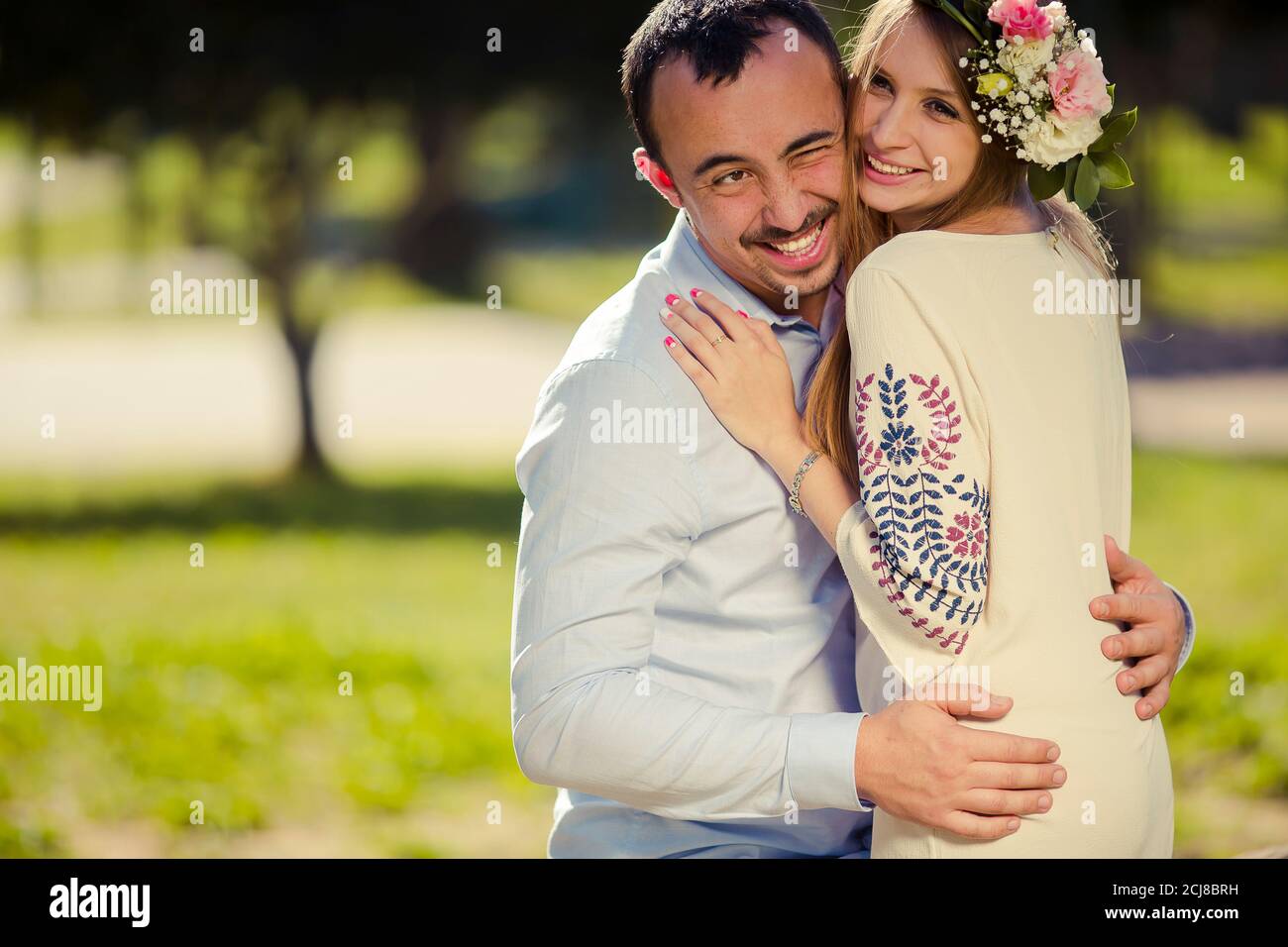 couple in love hugging and smiling in the park Stock Photo - Alamy