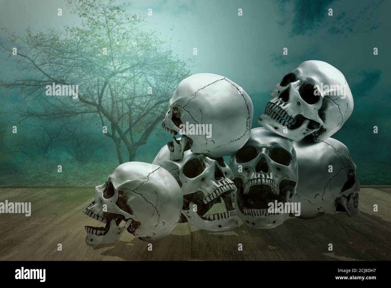 Stack of a human skull on the wooden floor with smoke and fog in the ...