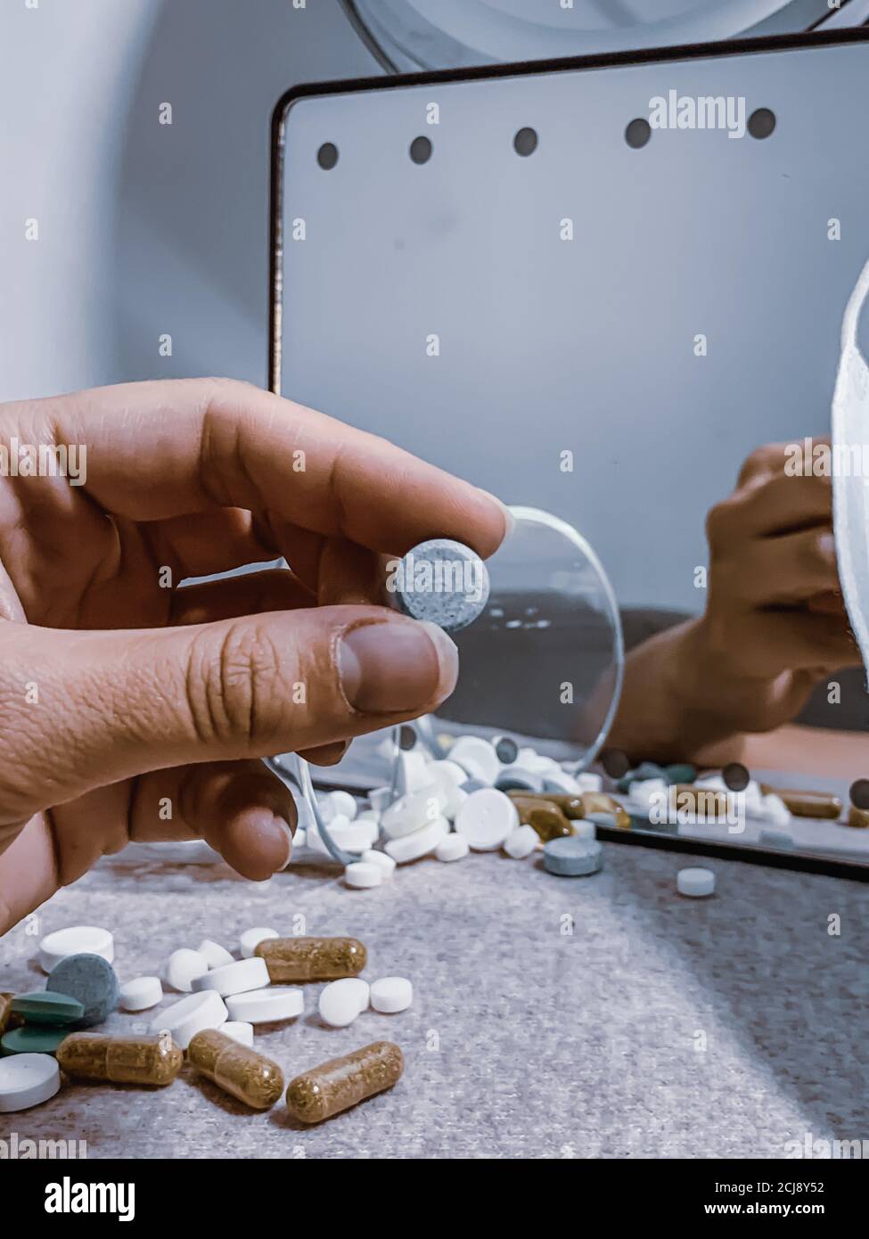 Vertical shot of a person holding medicine pills - drug addiction ...